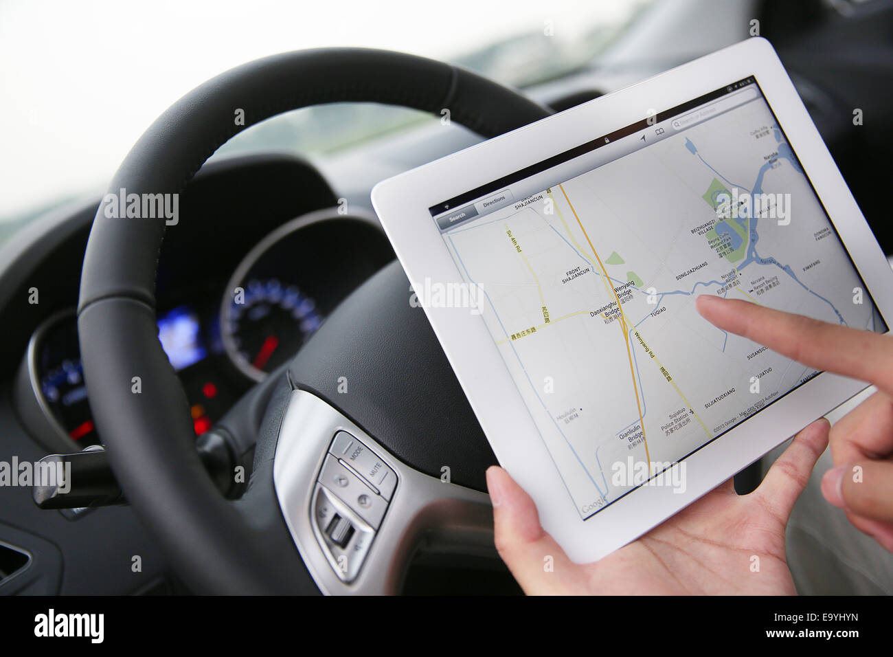 Young man using Ipad Stock Photo - Alamy