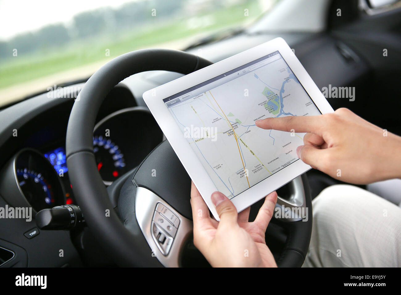 Young man using Ipad Stock Photo - Alamy