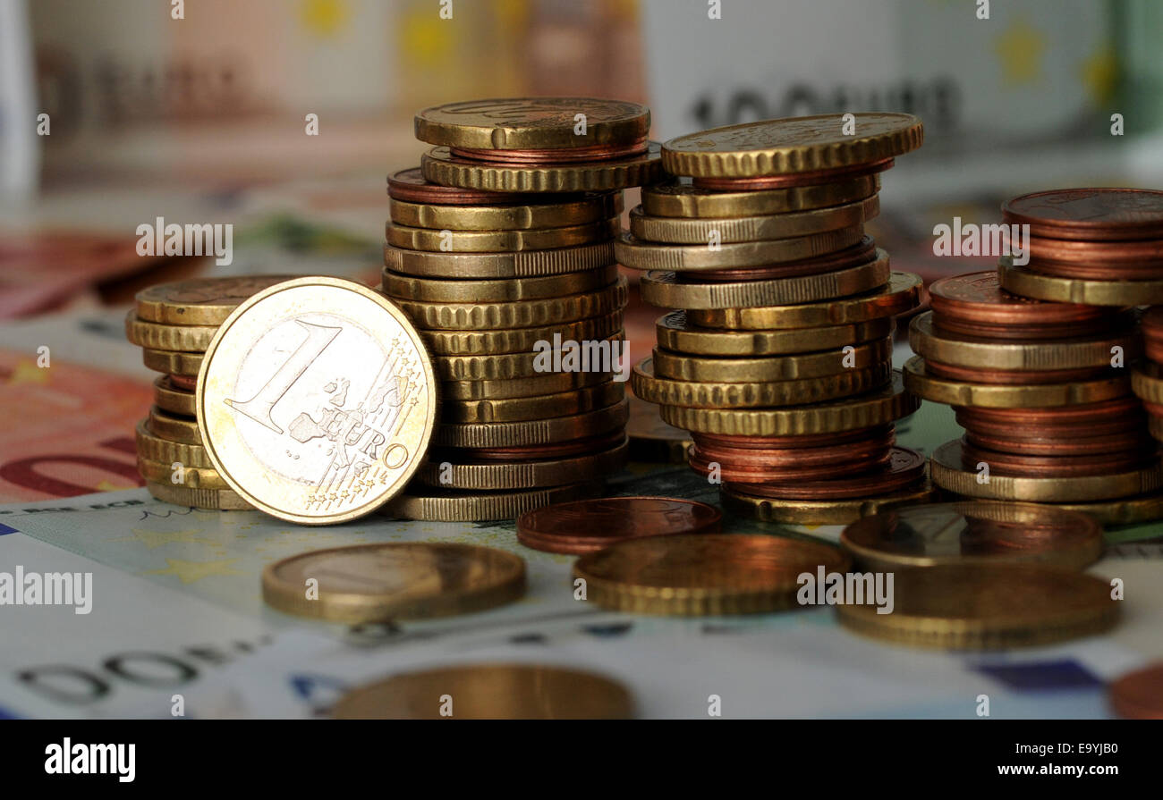 ILLUSTRATION - Coins stacked on top of banknotes in Munich, German, 04 ...