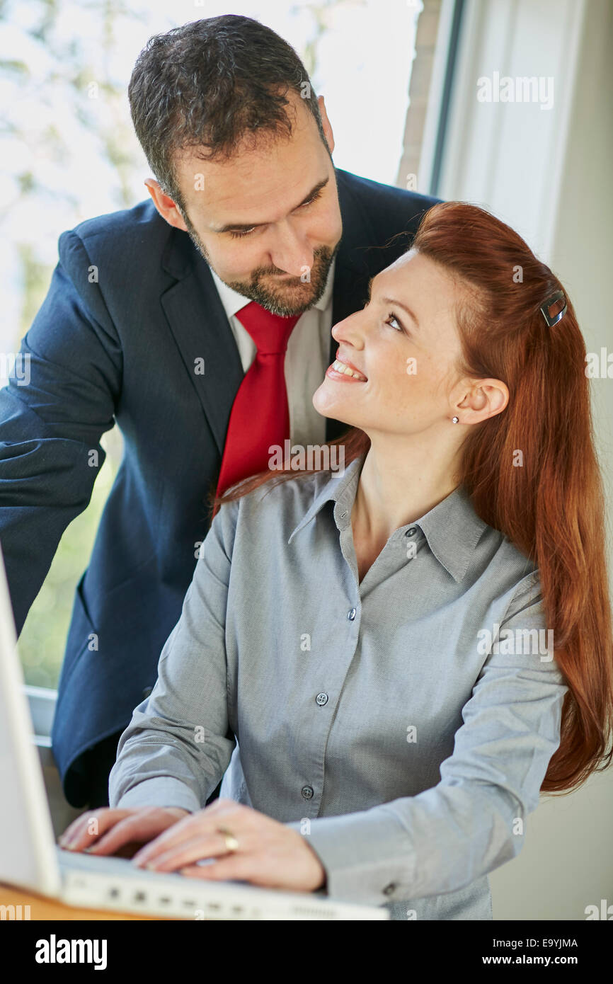 Couple flirting at work Stock Photo - Alamy