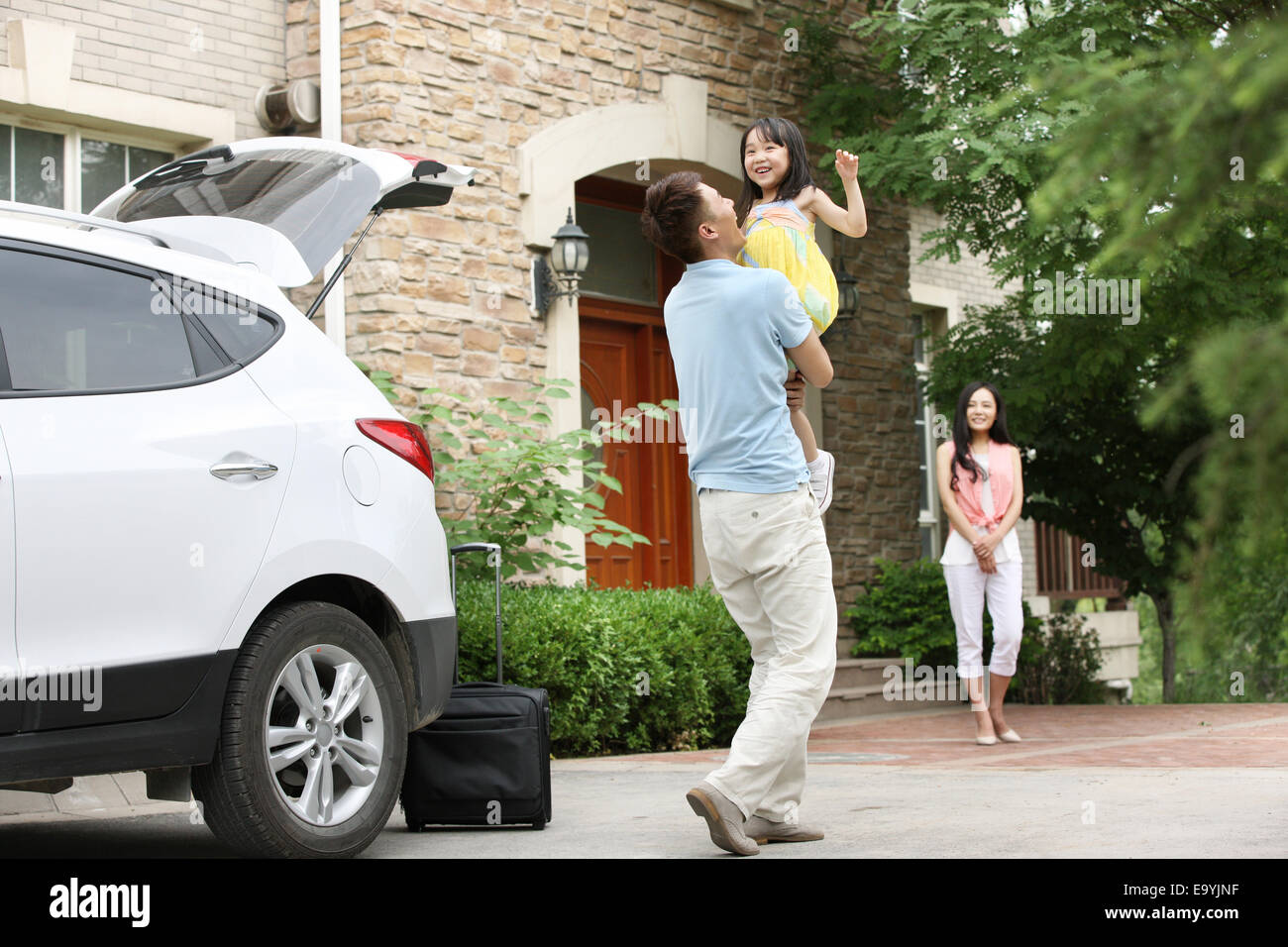 Girl with parents Stock Photo - Alamy