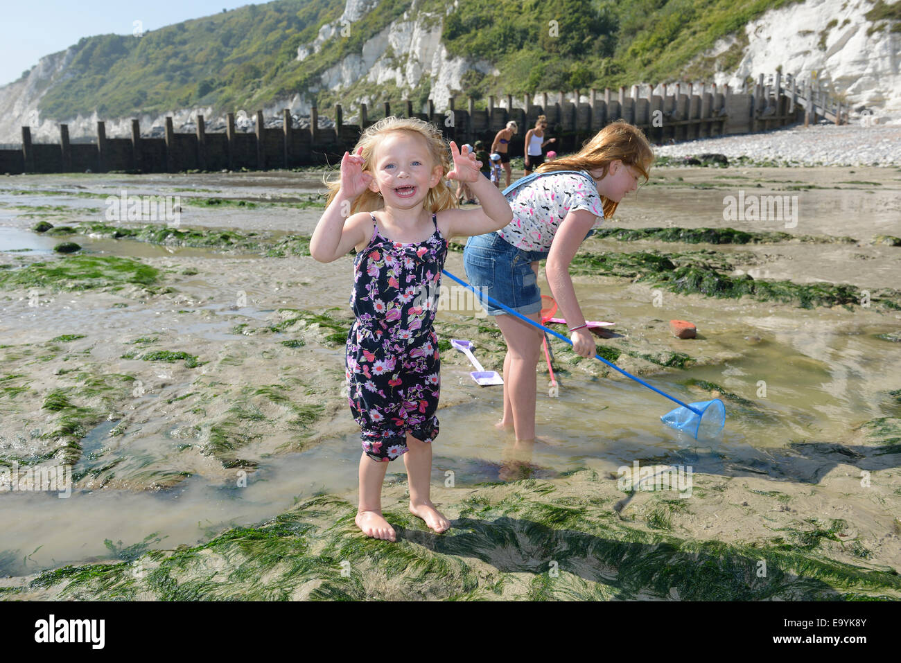 Children rock pooling at Holywell Retreat, South Downs. Eastbourne. UK ...