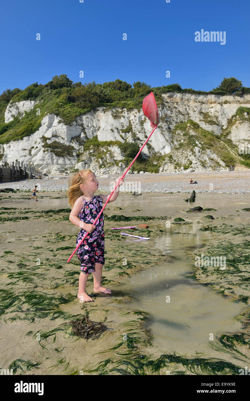 Child rock pooling at Holywell Retreat, South Downs. Eastbourne. UK ...