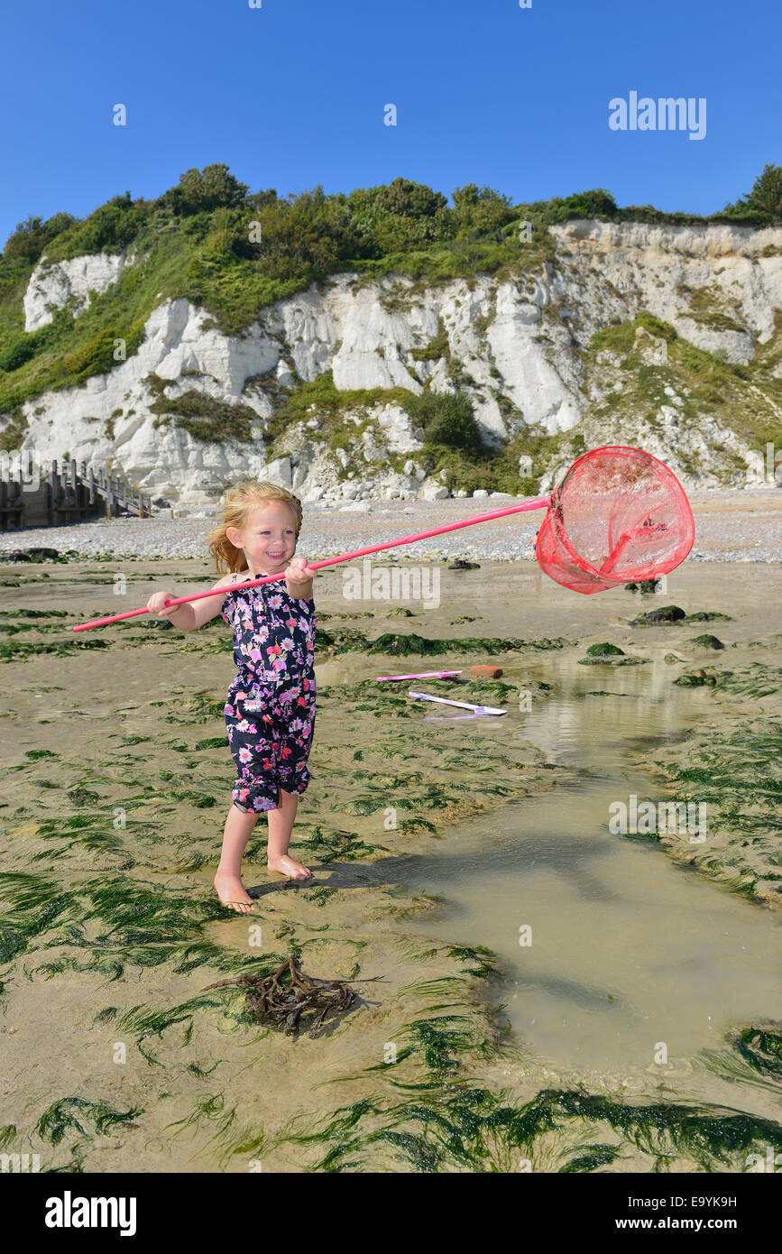Child rock pooling at Holywell Retreat, South Downs. Eastbourne. UK ...