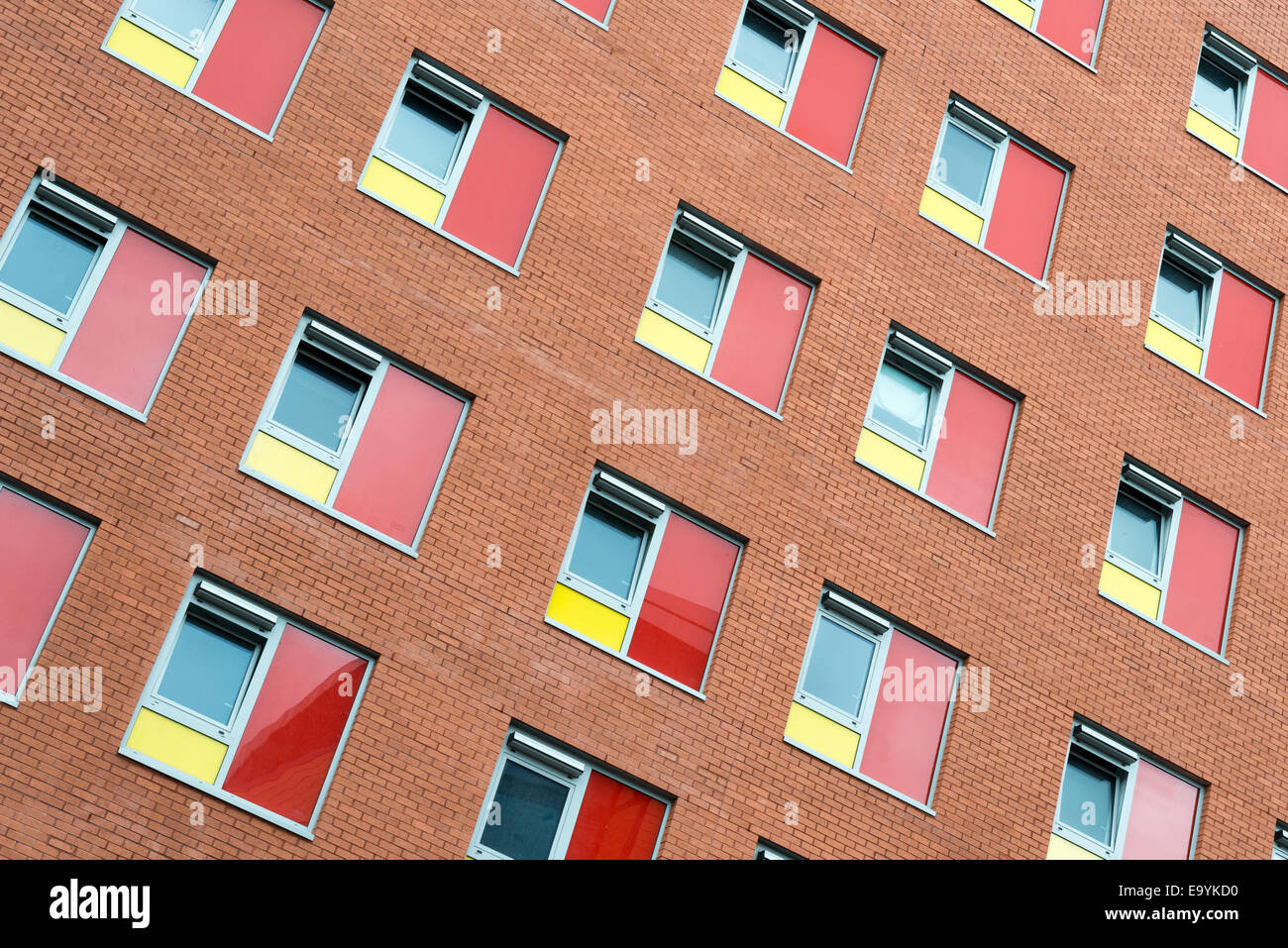 Bright coloured red and yellow windows a building with flats in Glasgow ...