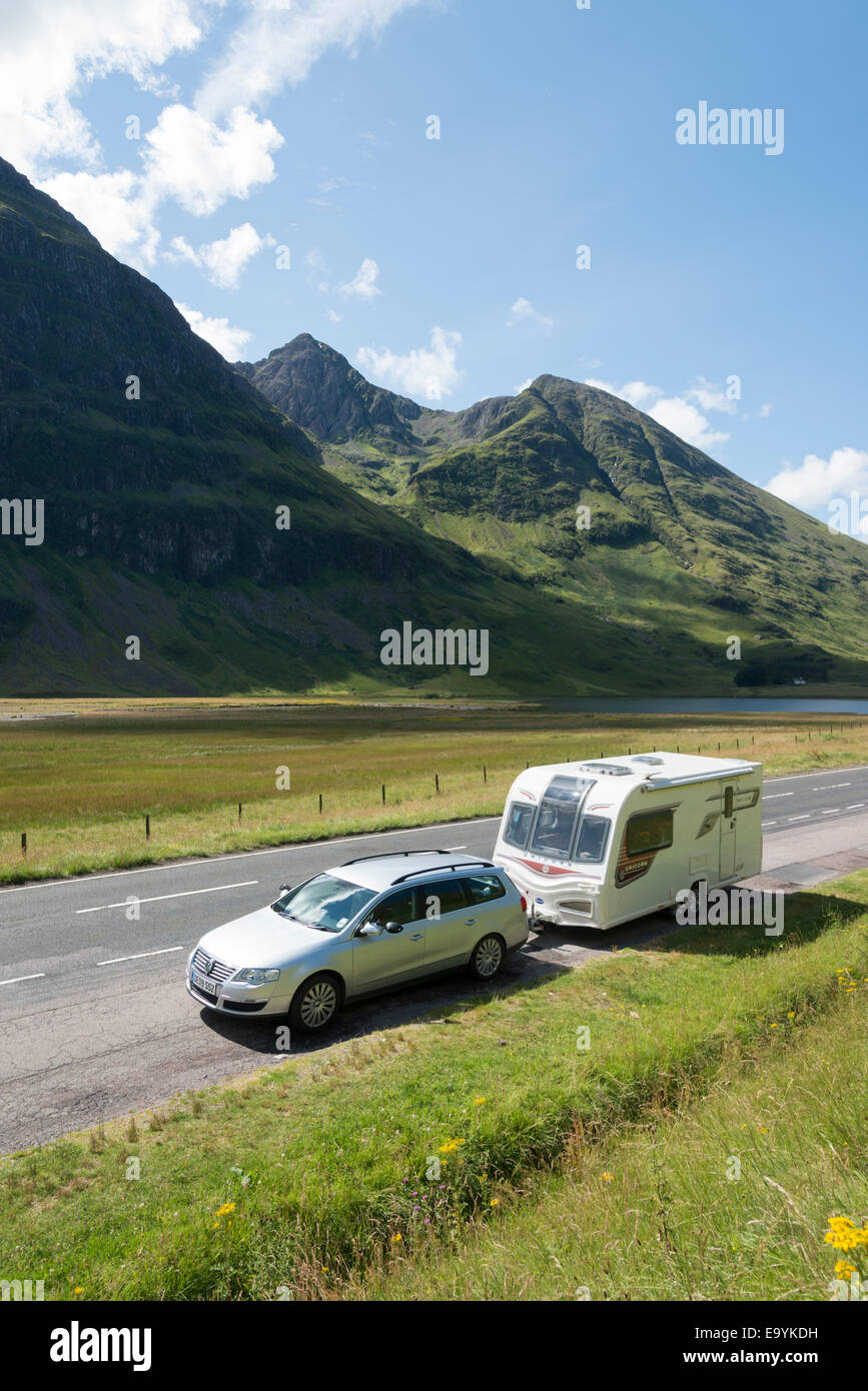 Car and caravan driving on the A82 road through Glen Coe in the ...