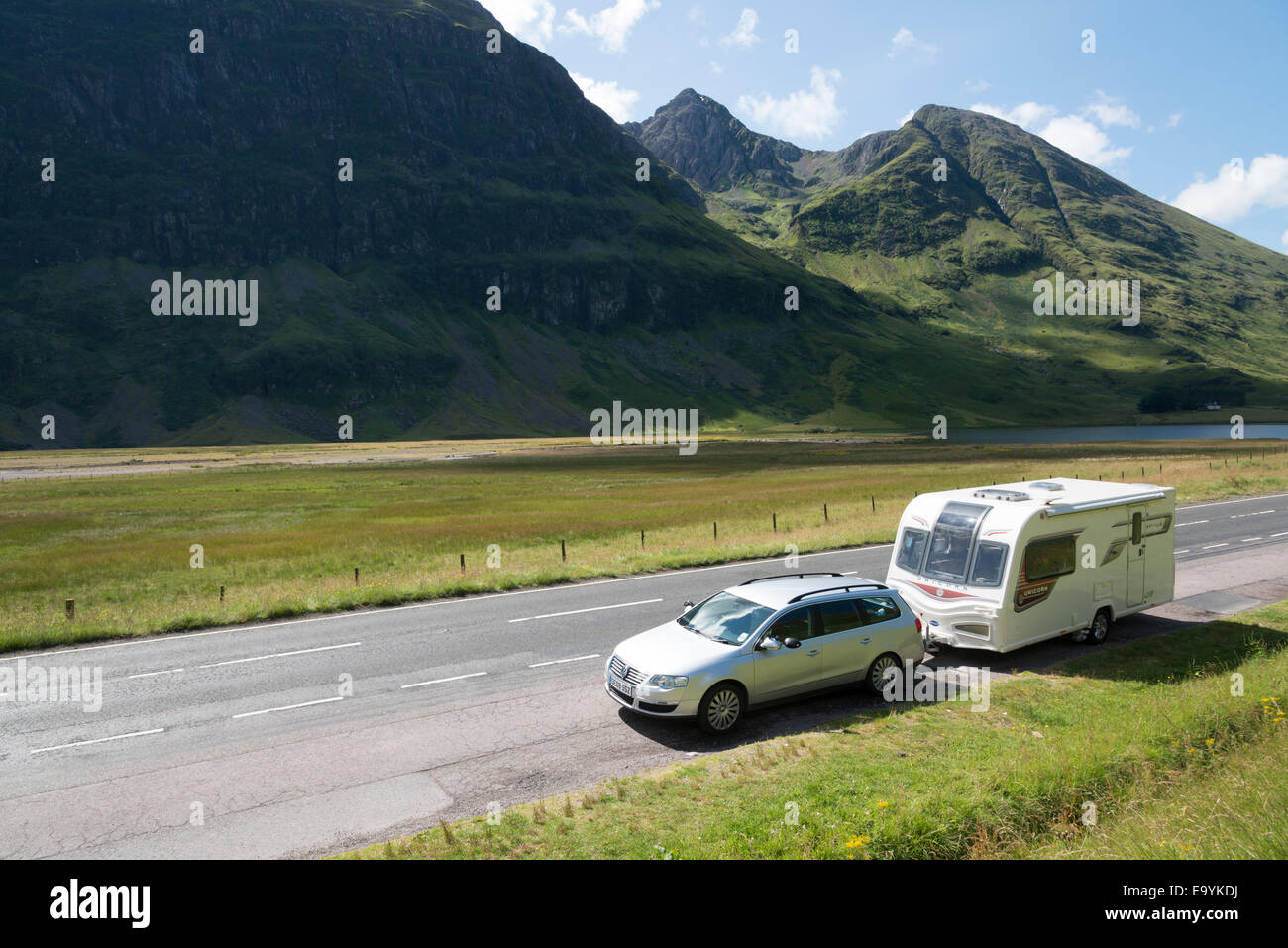 Car and caravan driving on the A82 road through Glen Coe in the ... Car and caravan driving on the A82 road through Glen Coe in the ...