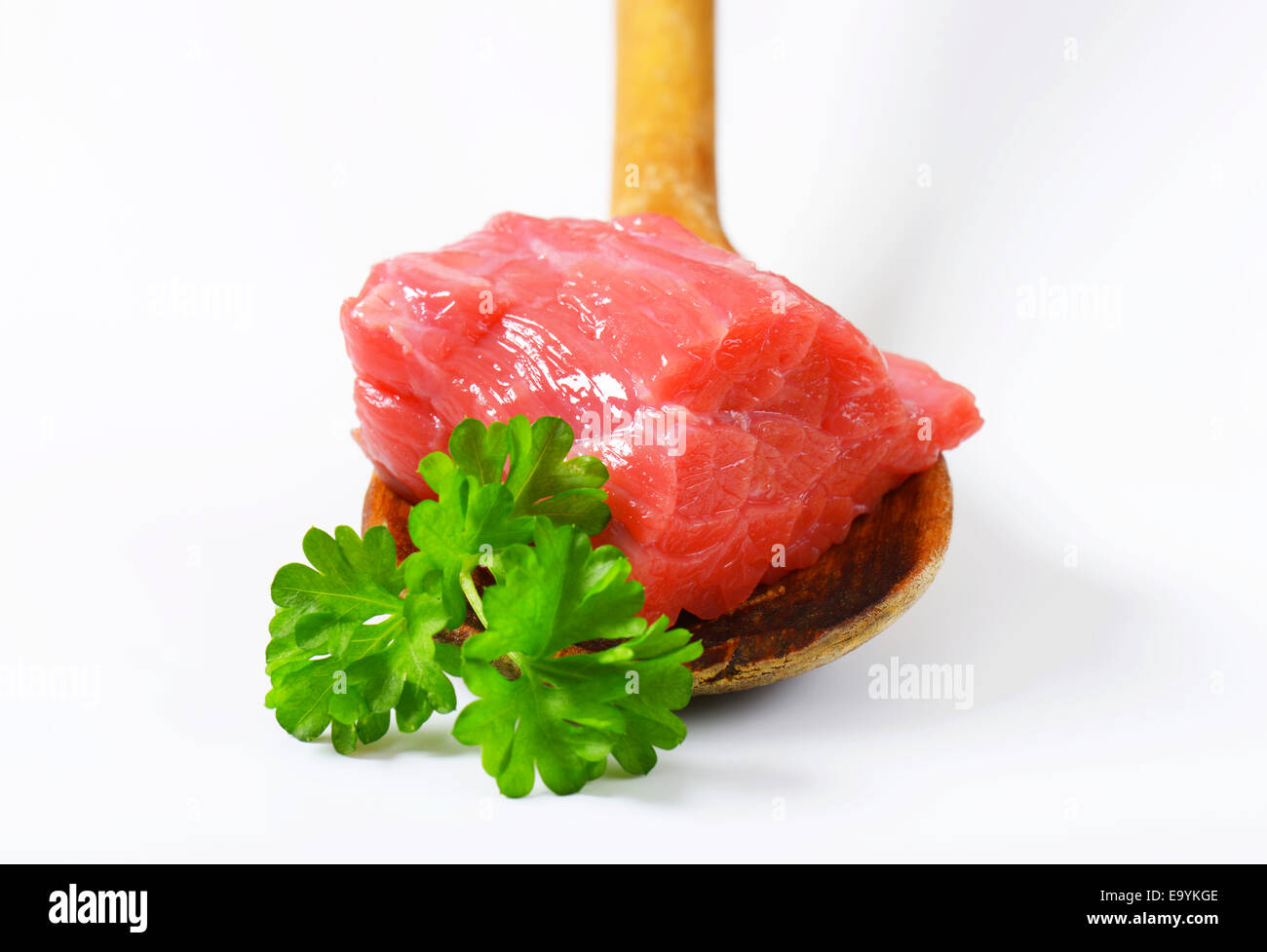 Chunk of raw beef meat on wooden spoon Stock Photo - Alamy