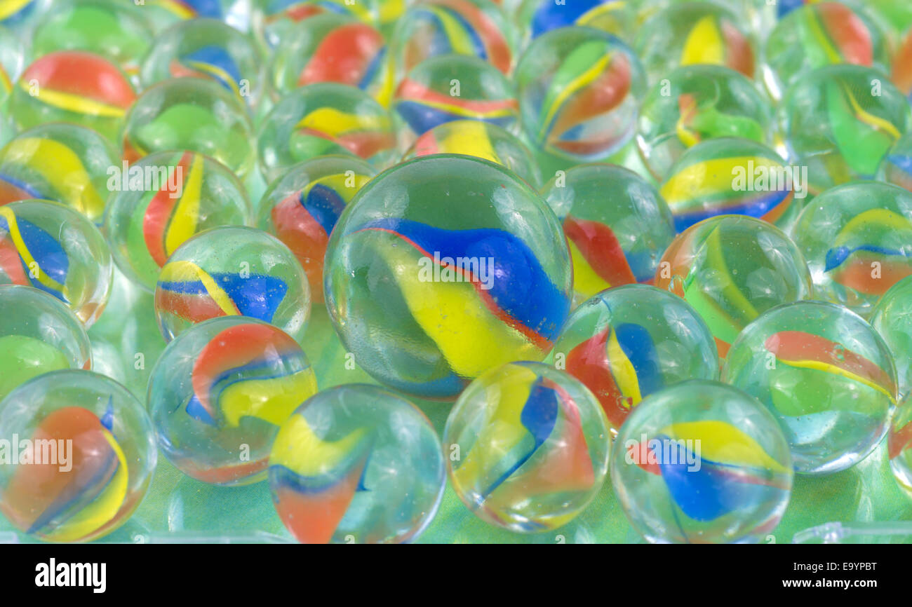 A group of marbles with a large shooter marble on top Stock Photo - Alamy