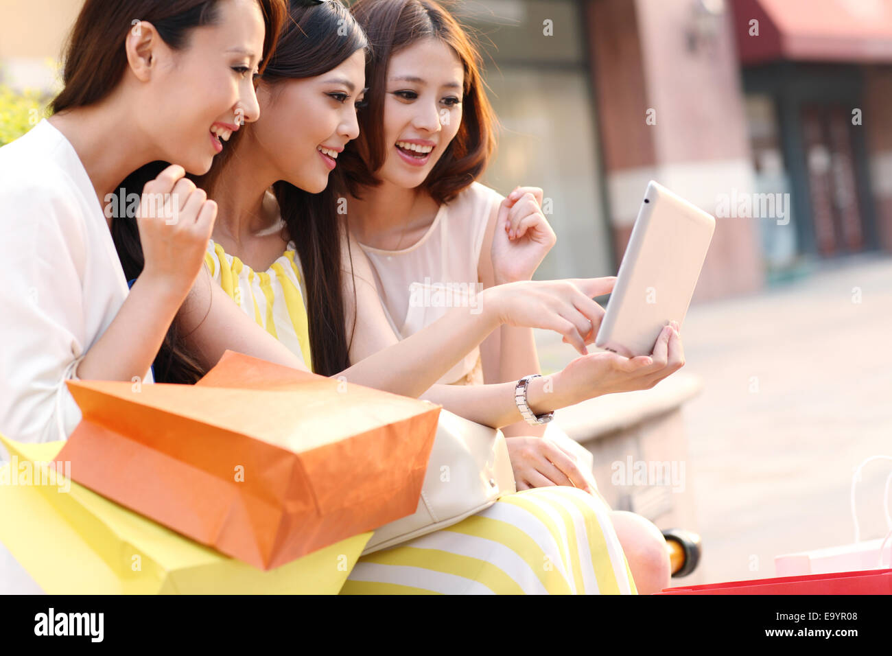 Young women using Ipad Stock Photo - Alamy