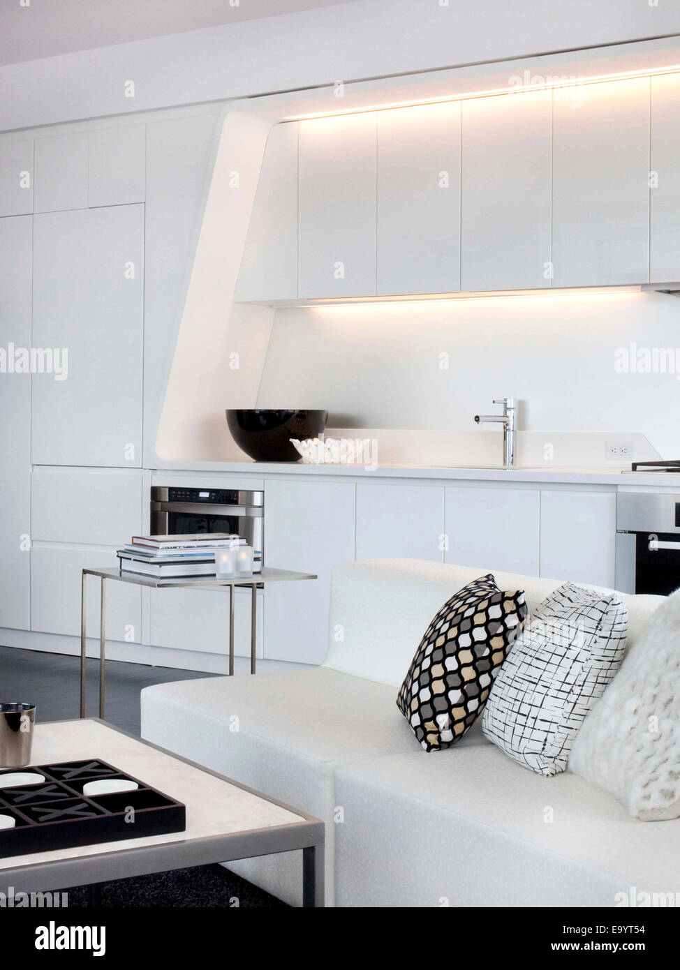 all white couch and kitchen in loft apartment Stock Photo - Alamy