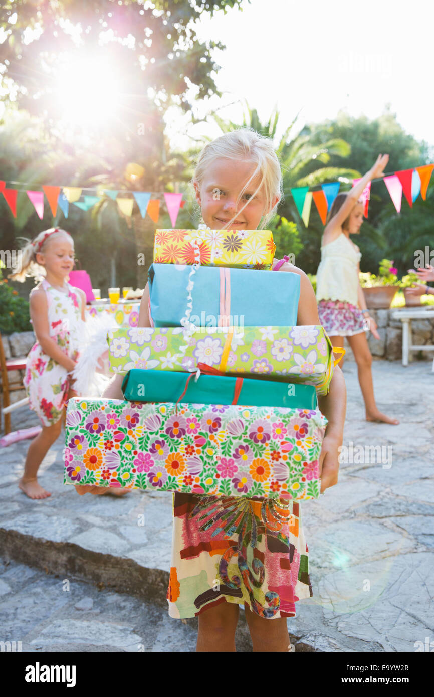Girl with stack of birthday presents Stock Photo - Alamy