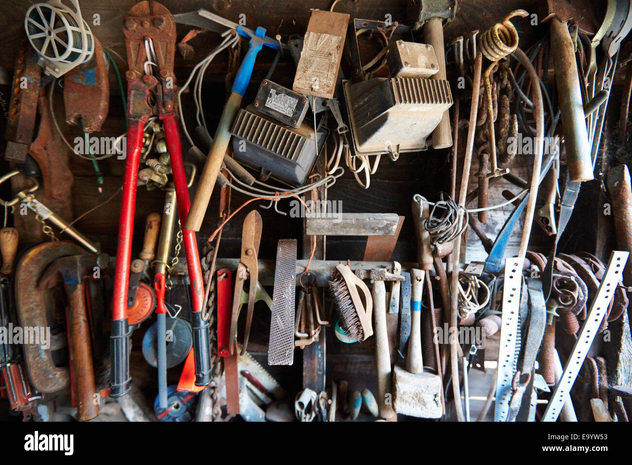 Old tools hanging on a wall in a farm workshop Stock Photo - Alamy