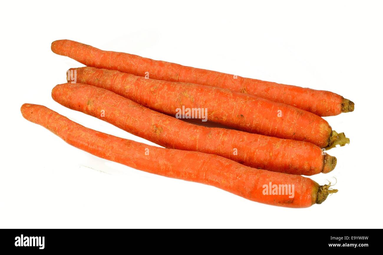Four carrots on a white background Stock Photo - Alamy