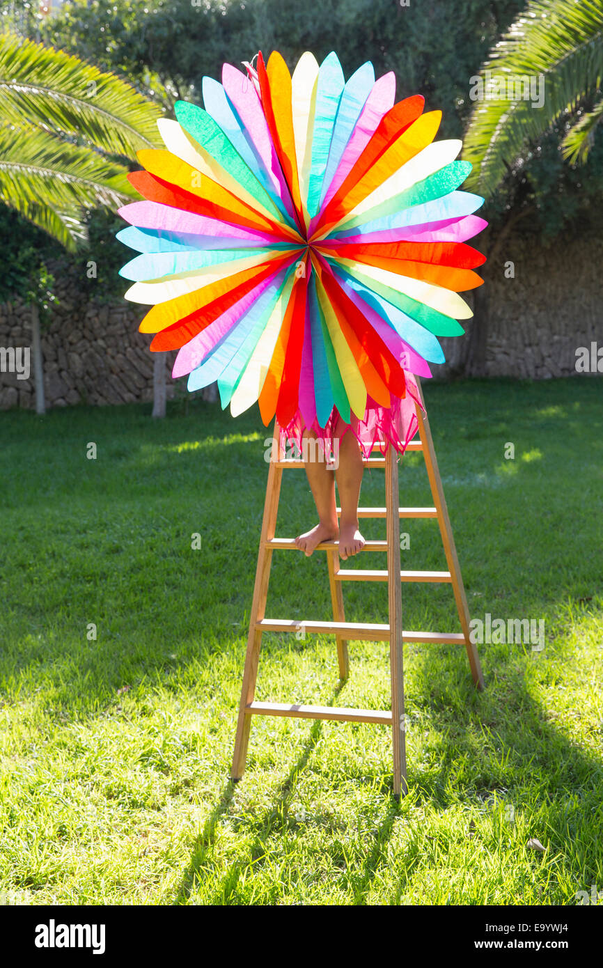 Girl putting up decoration in garden Stock Photo - Alamy