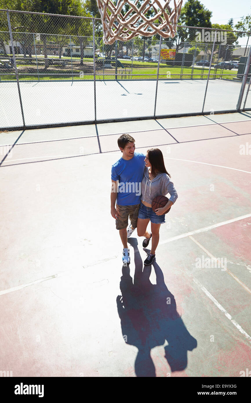 Young couple hugging in basketball court Stock Photo - Alamy