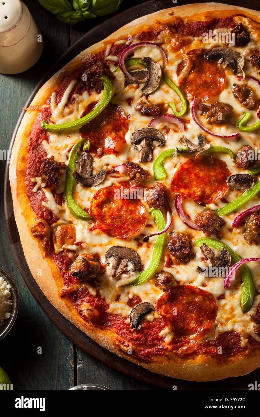 Homemade Hot Supreme PIzza with Pepperoni Peppers and Sausage Stock ...