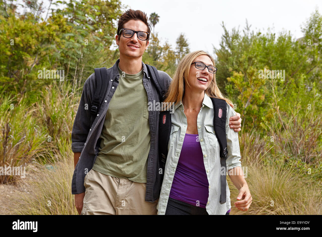 Couple enjoying walk in forest Stock Photo - Alamy
