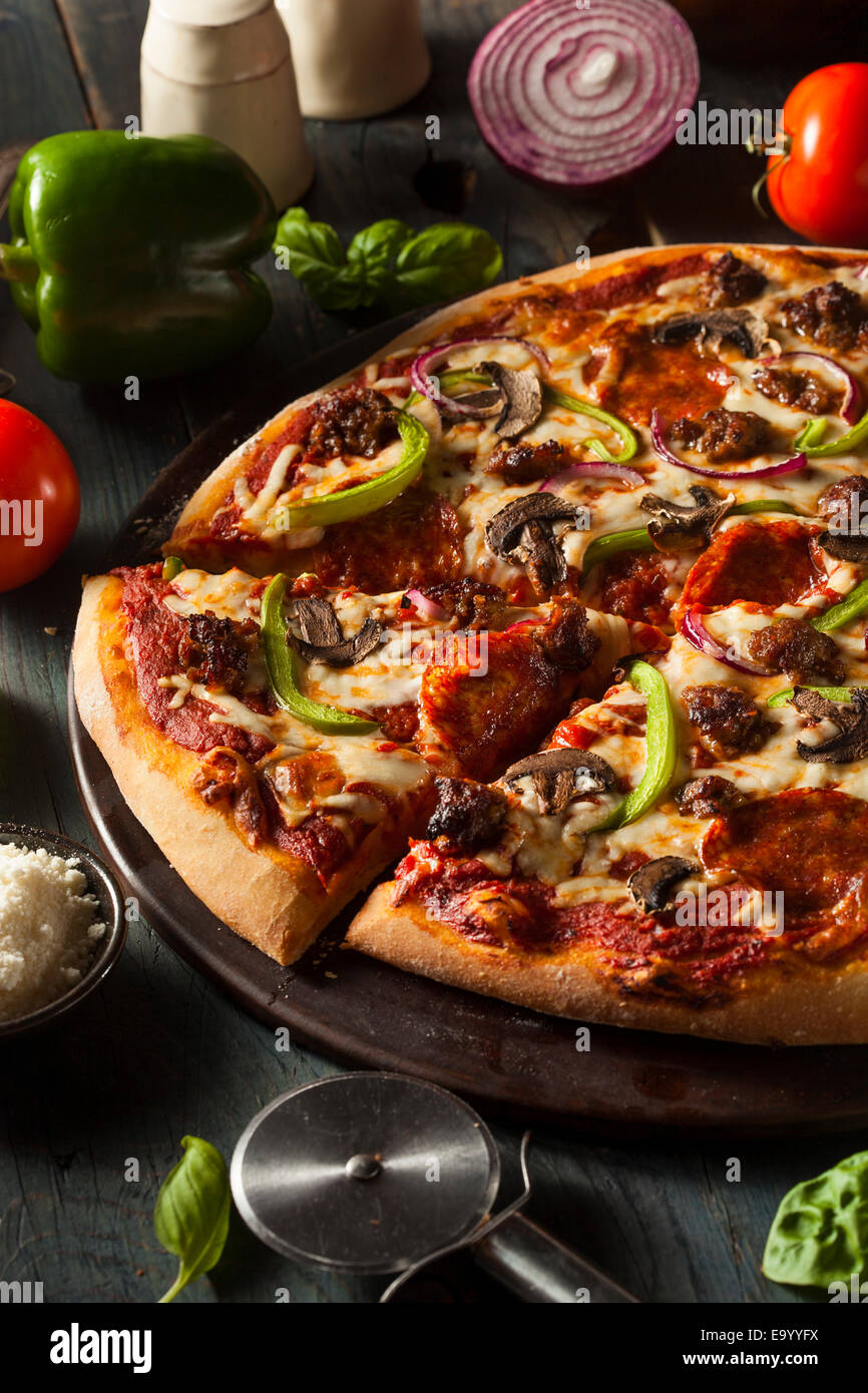 Homemade Hot Supreme PIzza with Pepperoni Peppers and Sausage Stock ...