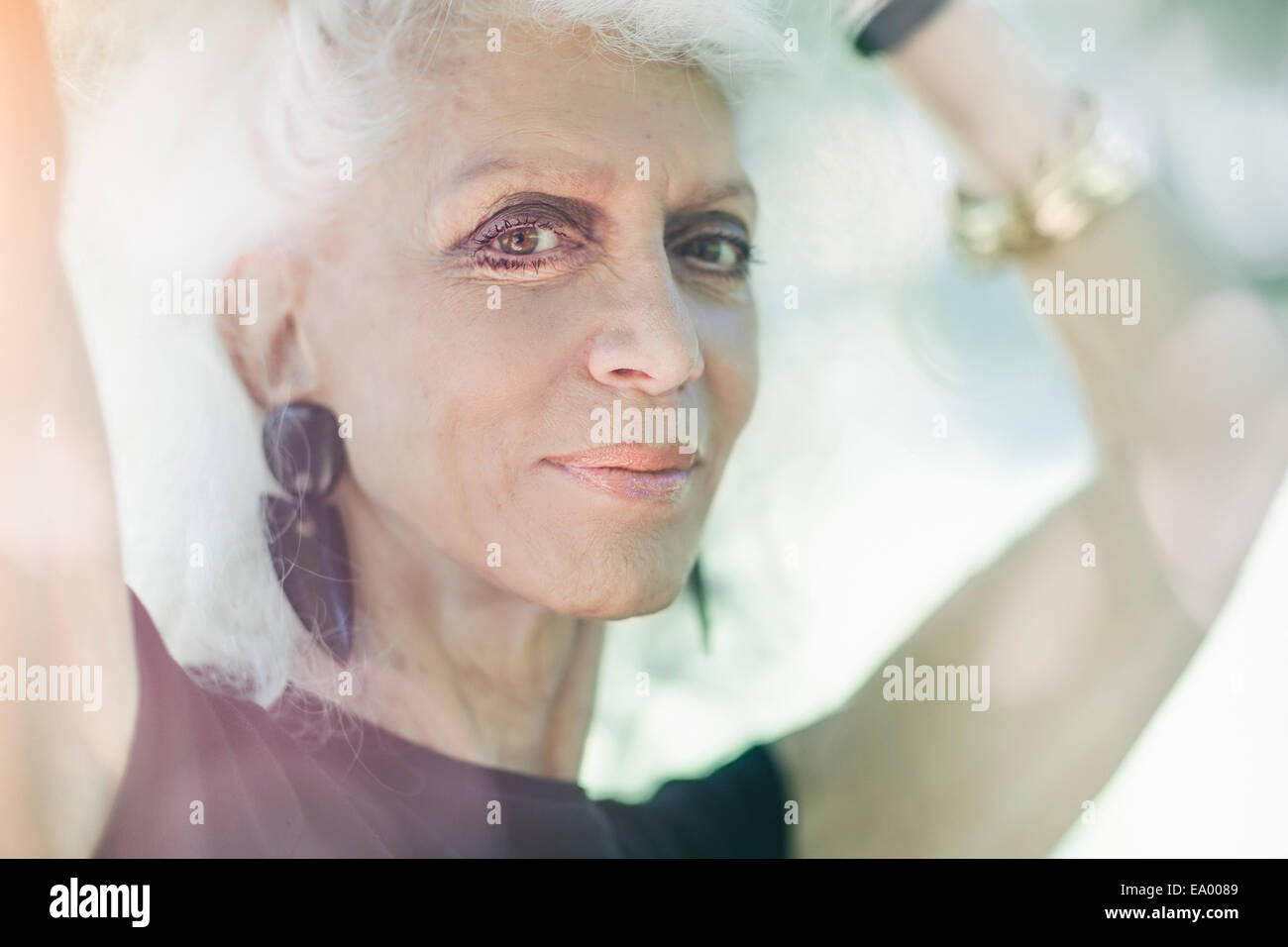Gray haired woman smiling with confidence Stock Photo - Alamy