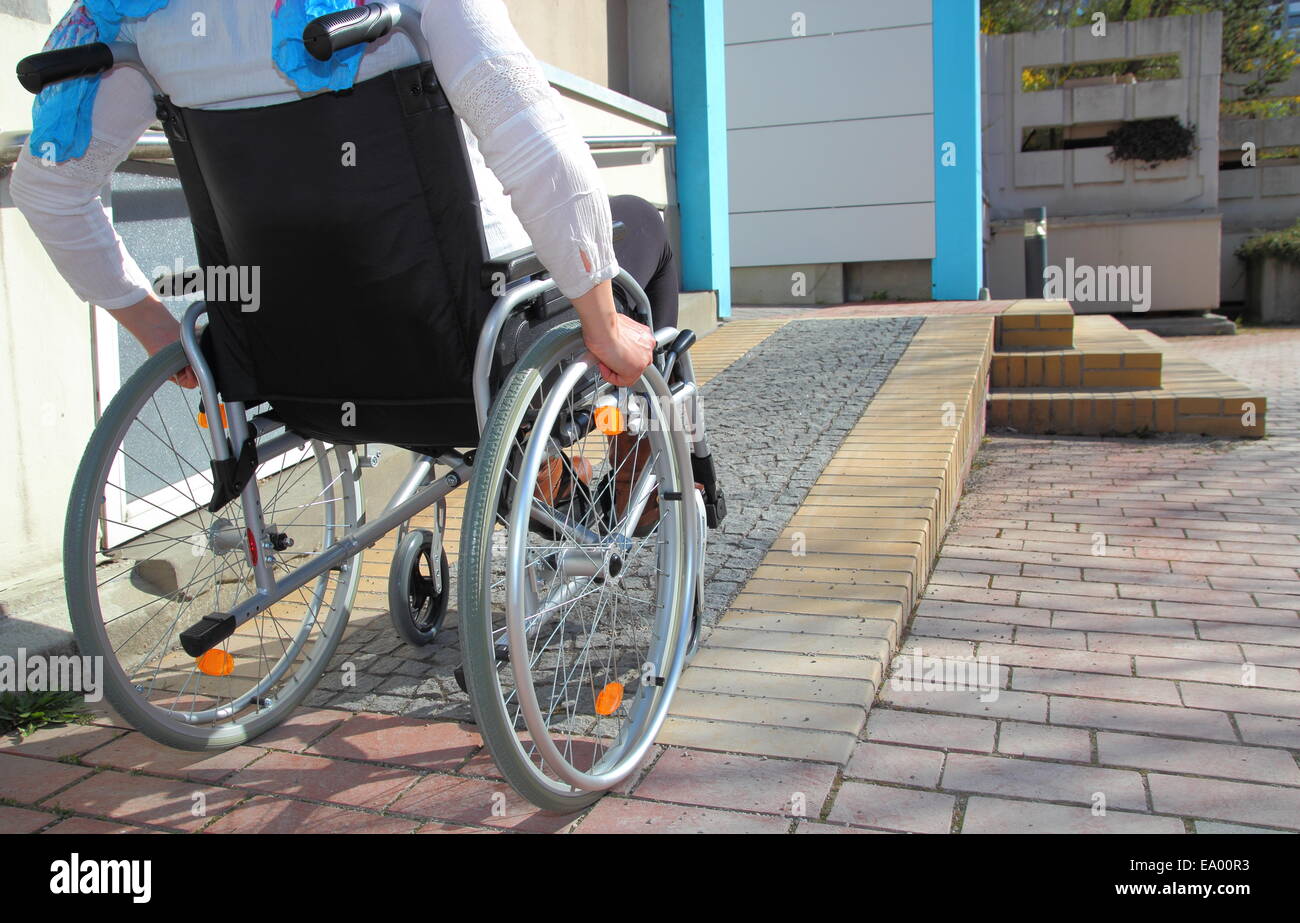 Woman in a wheelchair using a ramp Stock Photo - Alamy