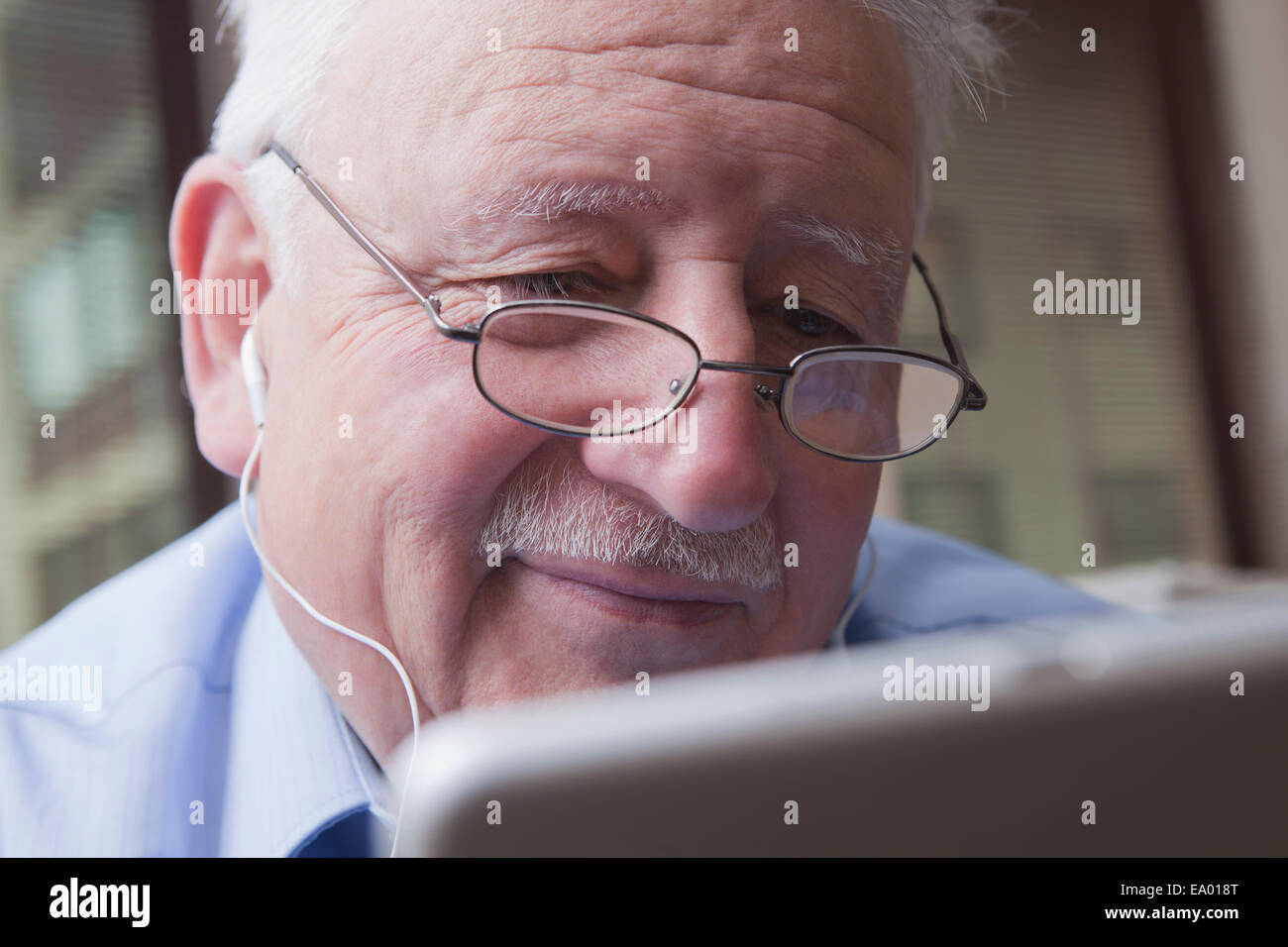 Senior man reading digital tablet Stock Photo - Alamy