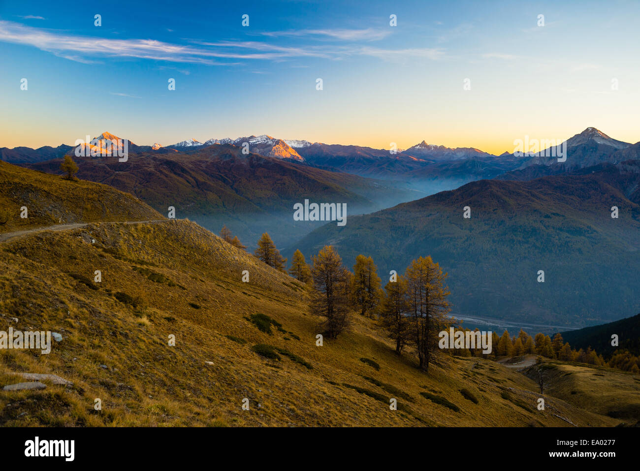 Last sunlight on high altitude alpine landscape at dusk with panoramic ...