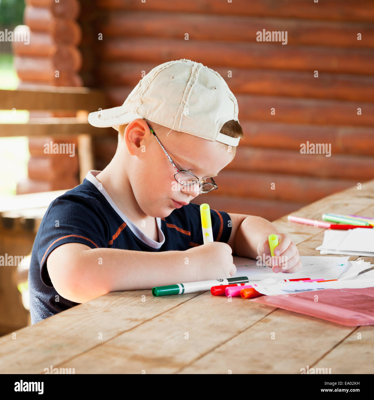 cute boy drawing in wooden gazebo outdoors Stock Photo - Alamy
