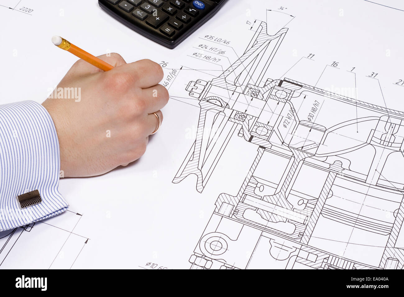 engineer's hand holding pen at draw Stock Photo - Alamy
