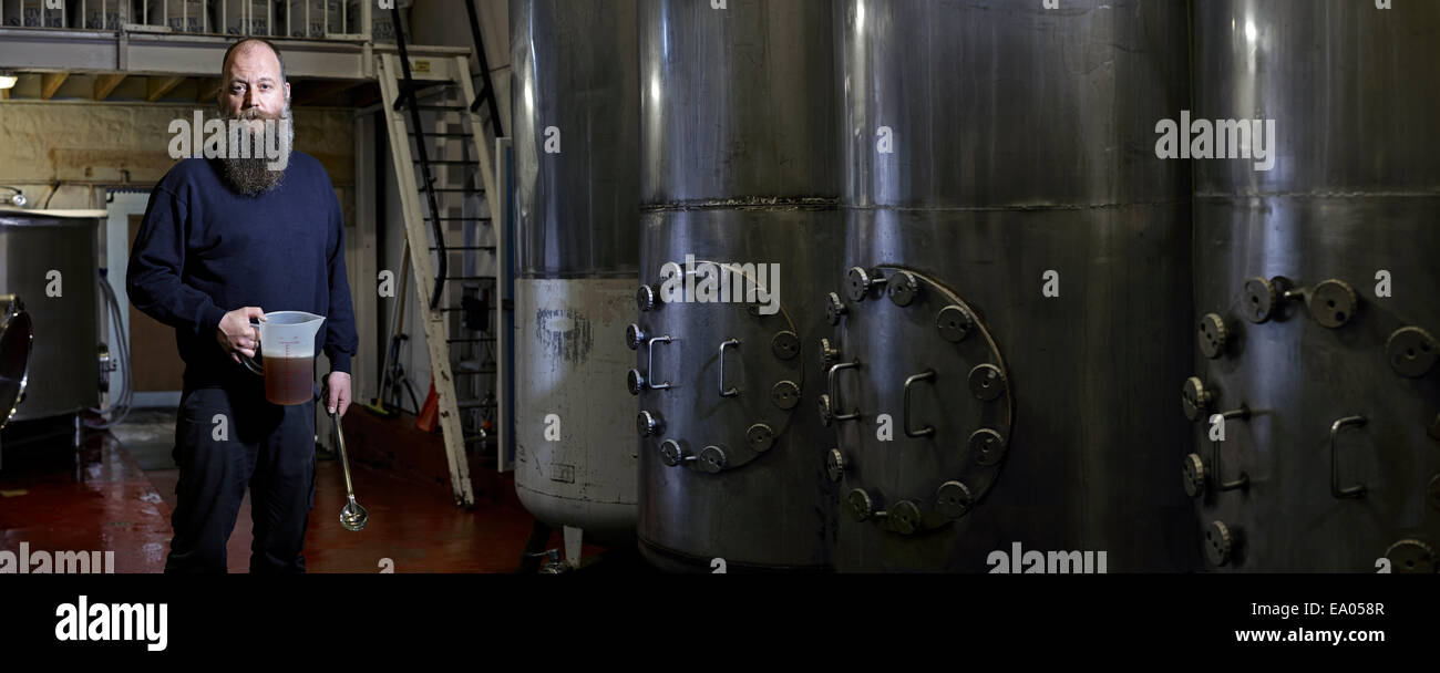 Portrait of a brewery worker in his working environment Stock Photo - Alamy