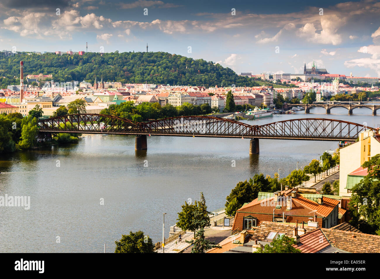 View of Prague from the Vltava river: house, trees, buildings and ...