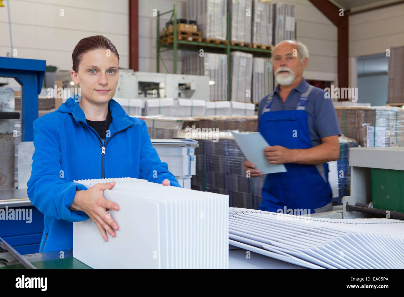 Factory workers working with cardboard Stock Photo - Alamy