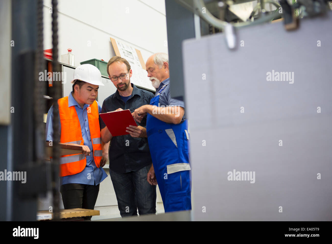 Factory workers with supervisor Stock Photo - Alamy