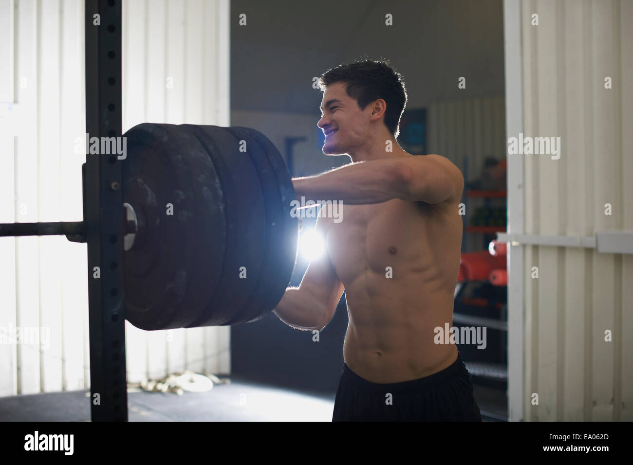 Man with barbells in gym Stock Photo - Alamy