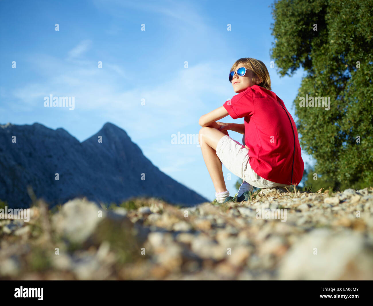 Boy sitting gazing at mountains hi-res stock photography and images - Alamy