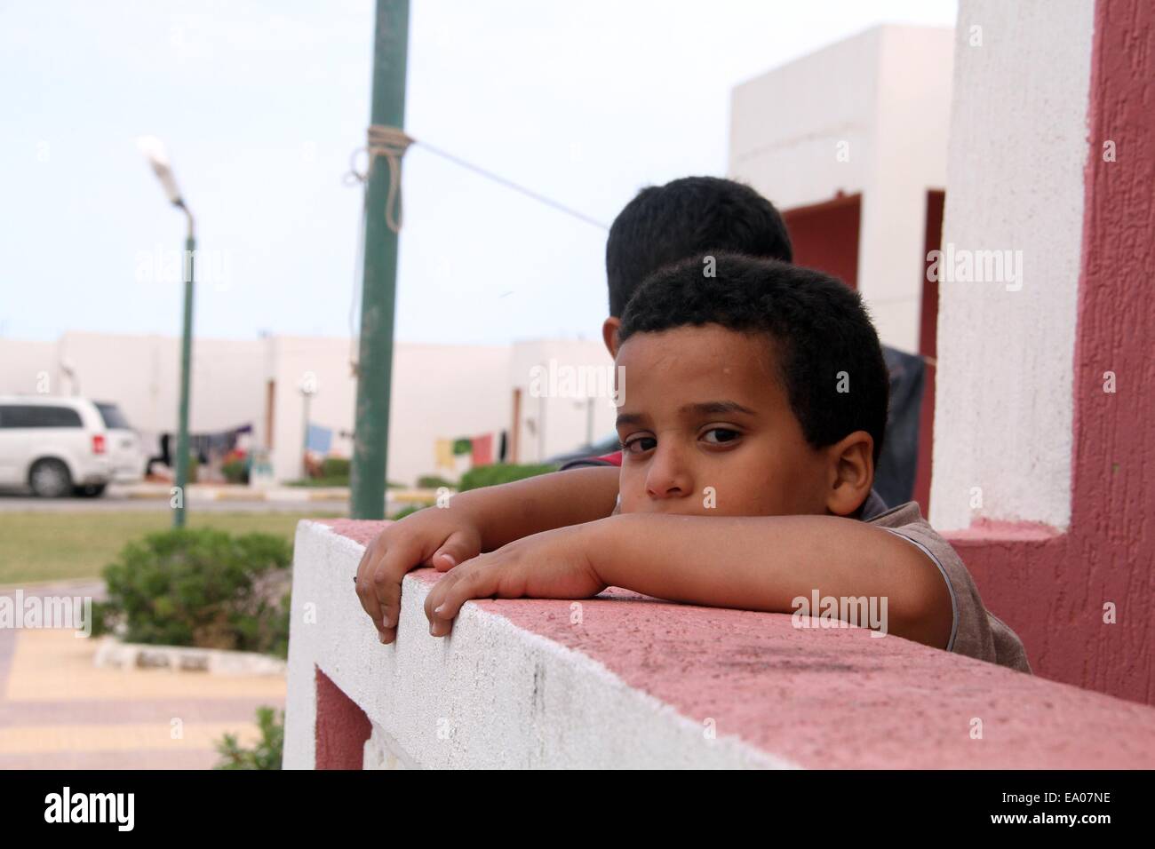Misrata, Libya. 4th Nov, 2014. Two boys look on from their balcony in a ...