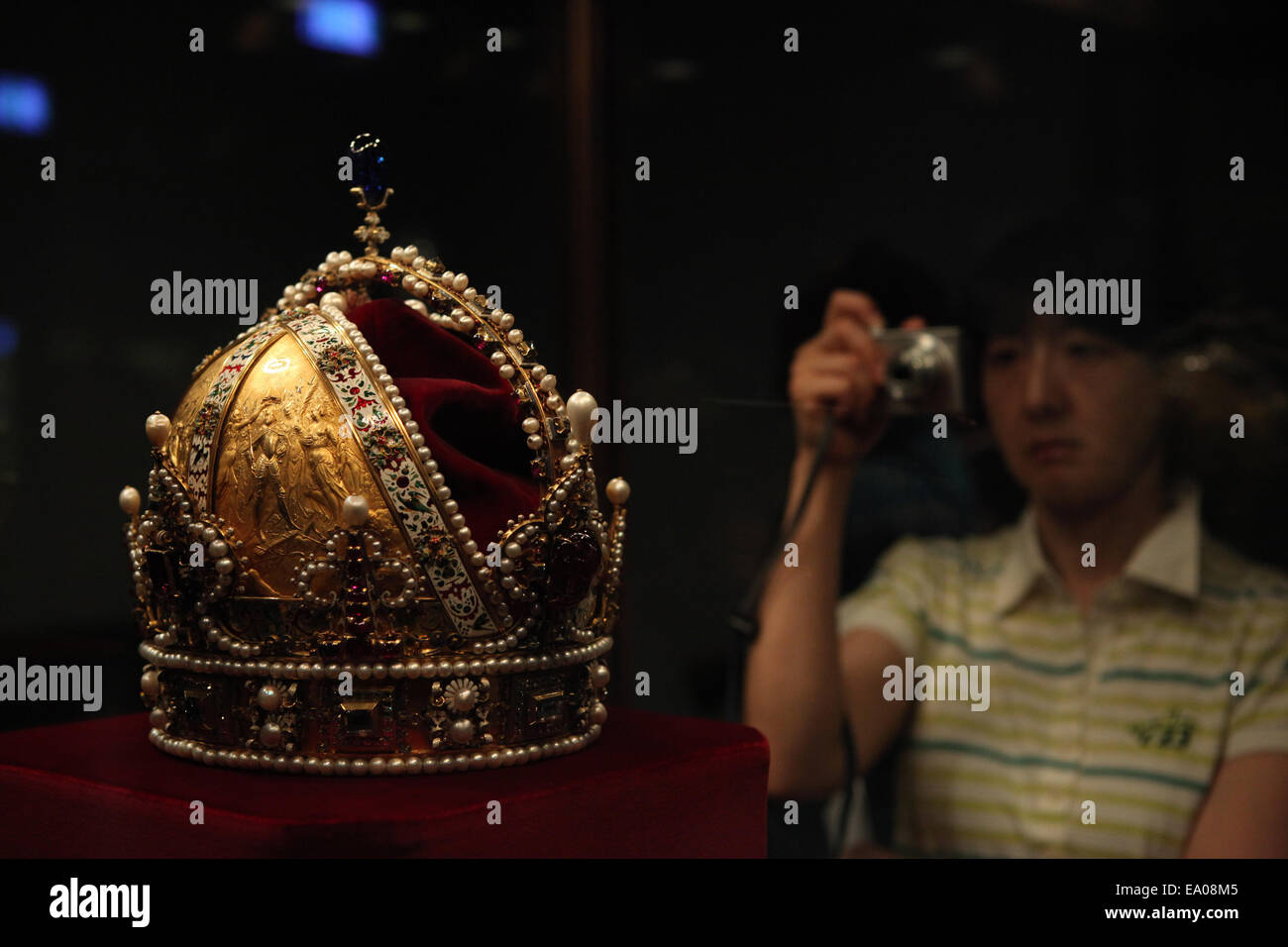 A visitor takes pictures of the Imperial Crown of Austria in the ...