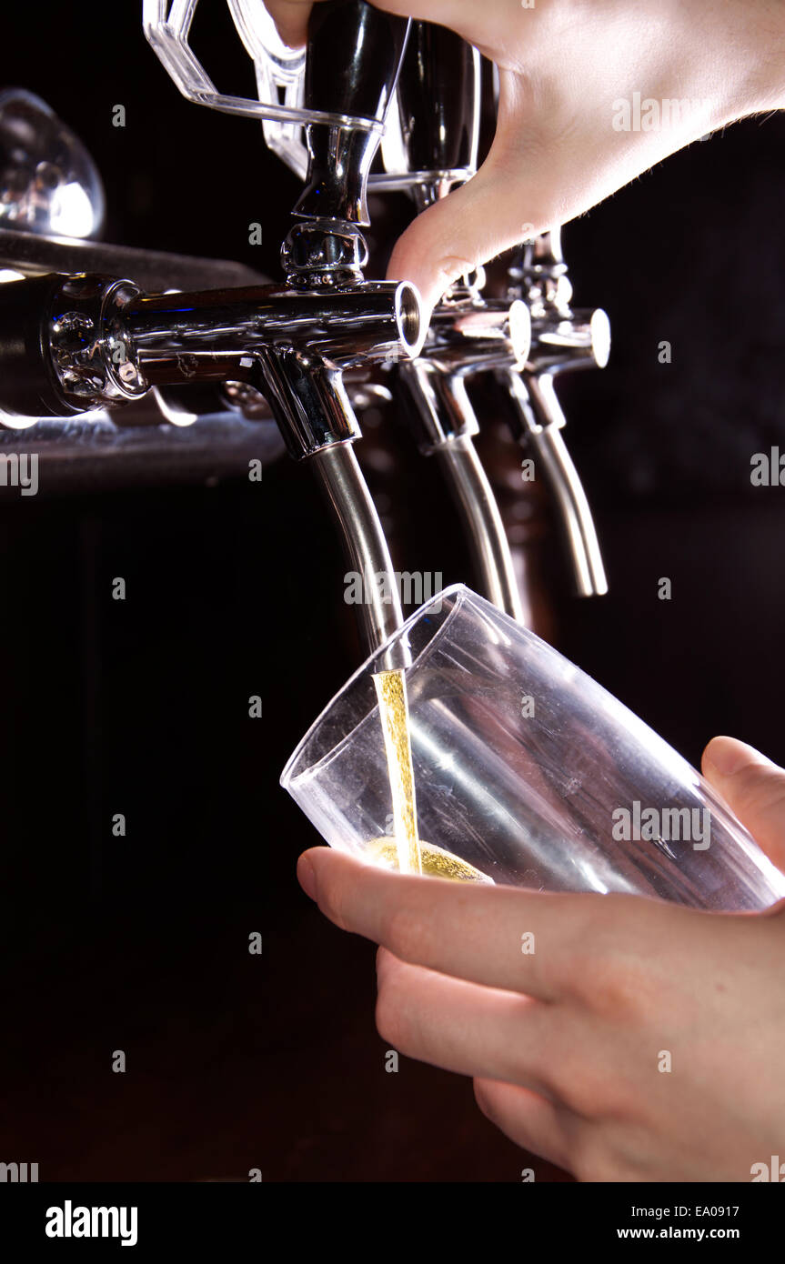 Alcohol conceptual image. Bartender giving the beer from dispenser ...