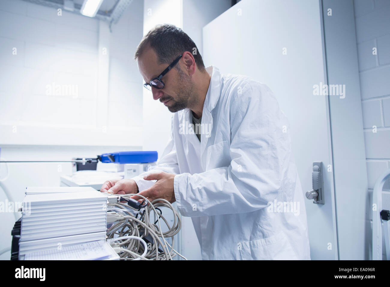 Lab assistant working on equipment Stock Photo - Alamy
