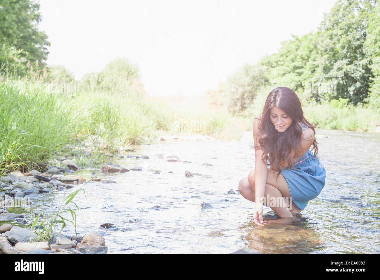 Young woman in shallow stream Stock Photo - Alamy