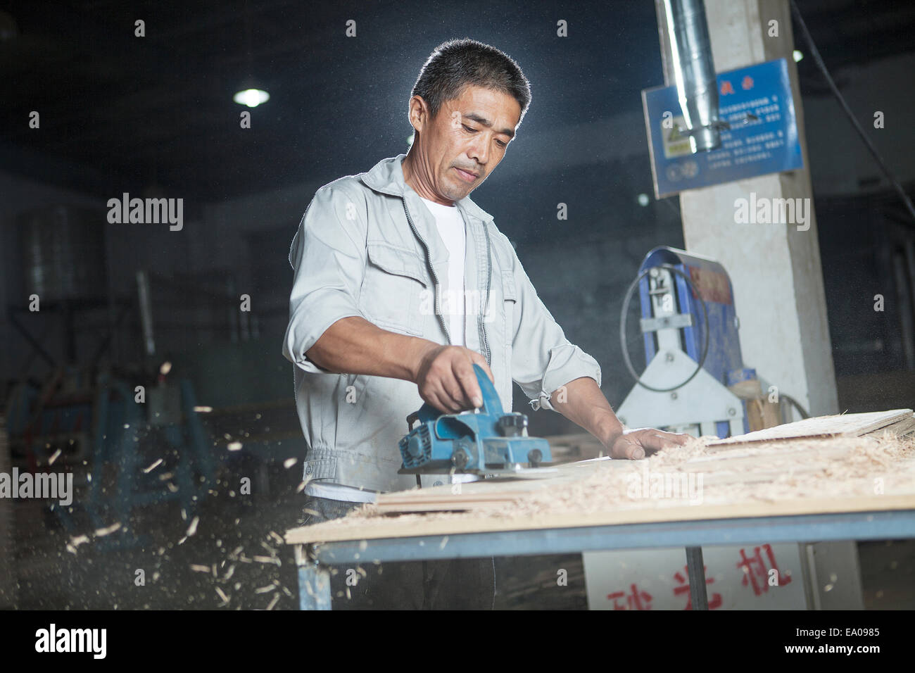 Carpenter cutting wood plank in factory, Jiangsu, China Stock Photo - Alamy
