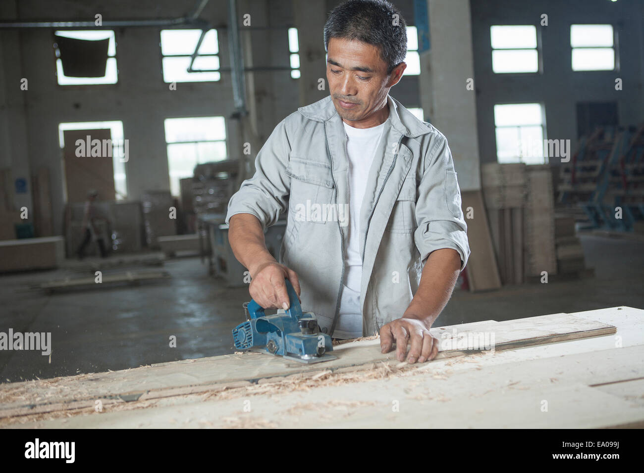 Carpenter cutting wood plank in factory, Jiangsu, China Stock Photo - Alamy