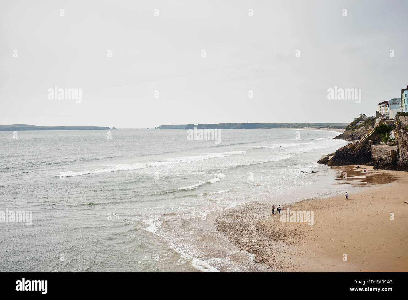 Distant view of people strolling on south beach, Tenby, Wales Stock ...