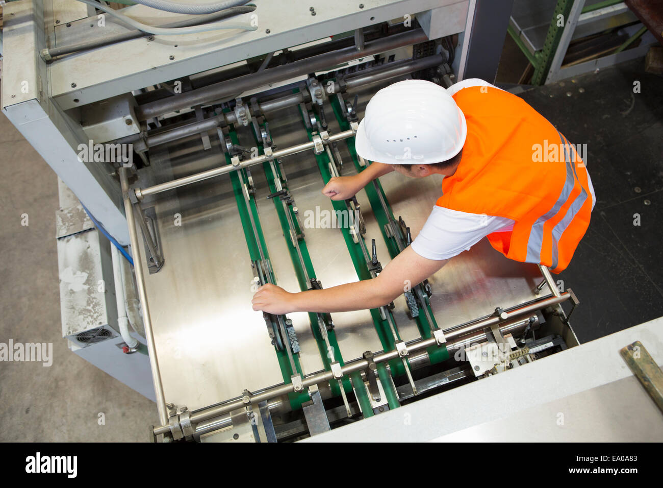 Factory worker working machinery Stock Photo - Alamy