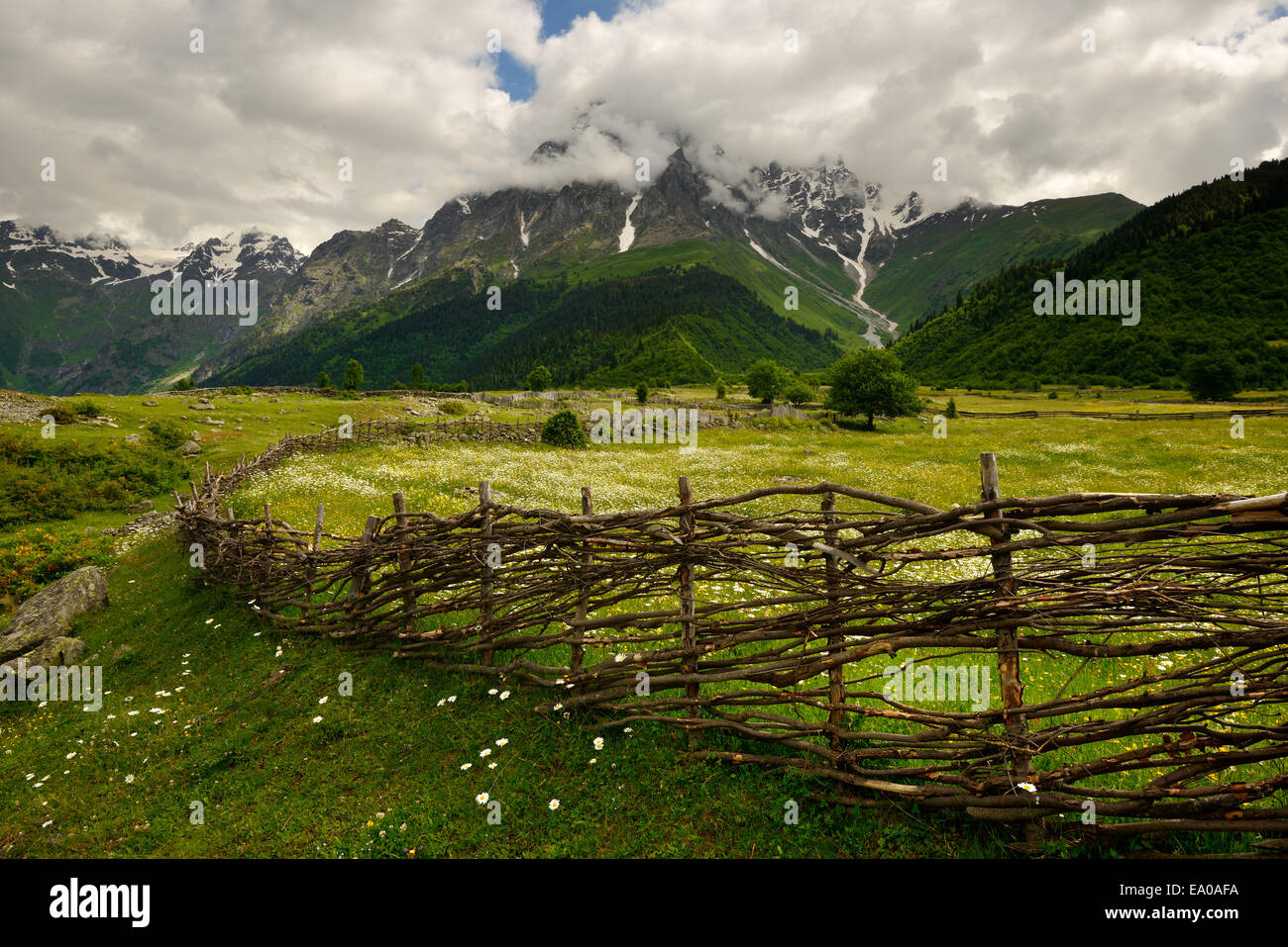 Hand woven fence and distant mountains, Mazeri village, Svaneti ...