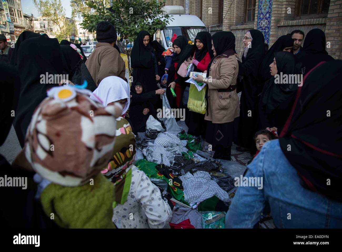 Sari, Iran. 29th Oct, 2014. A man mourns next to the mosque engaged in ...