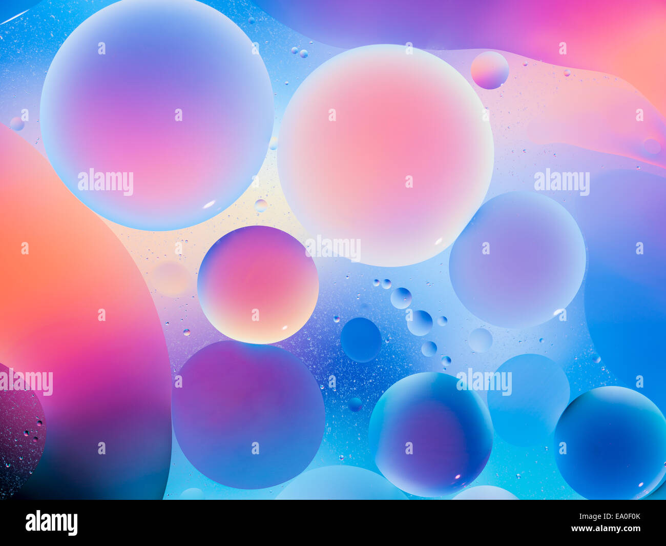 circular oild drops on water surface with colorful bright background ...