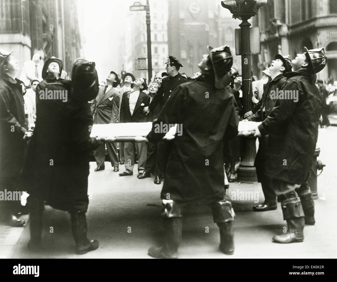 Firemen holding rescue trampoline Stock Photo - Alamy