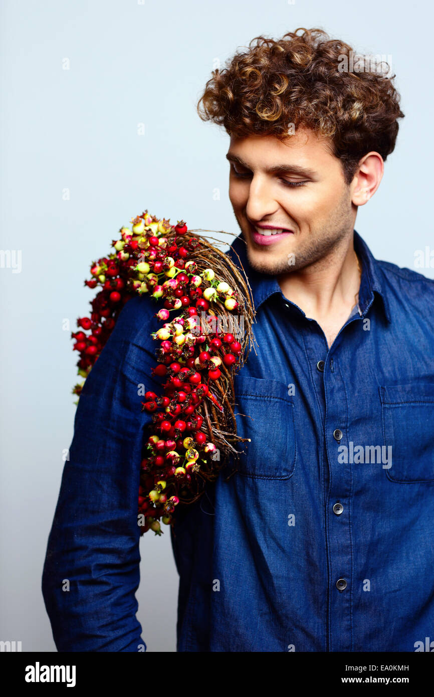 Portrait of a happy man with wreath on shoulder Stock Photo - Alamy