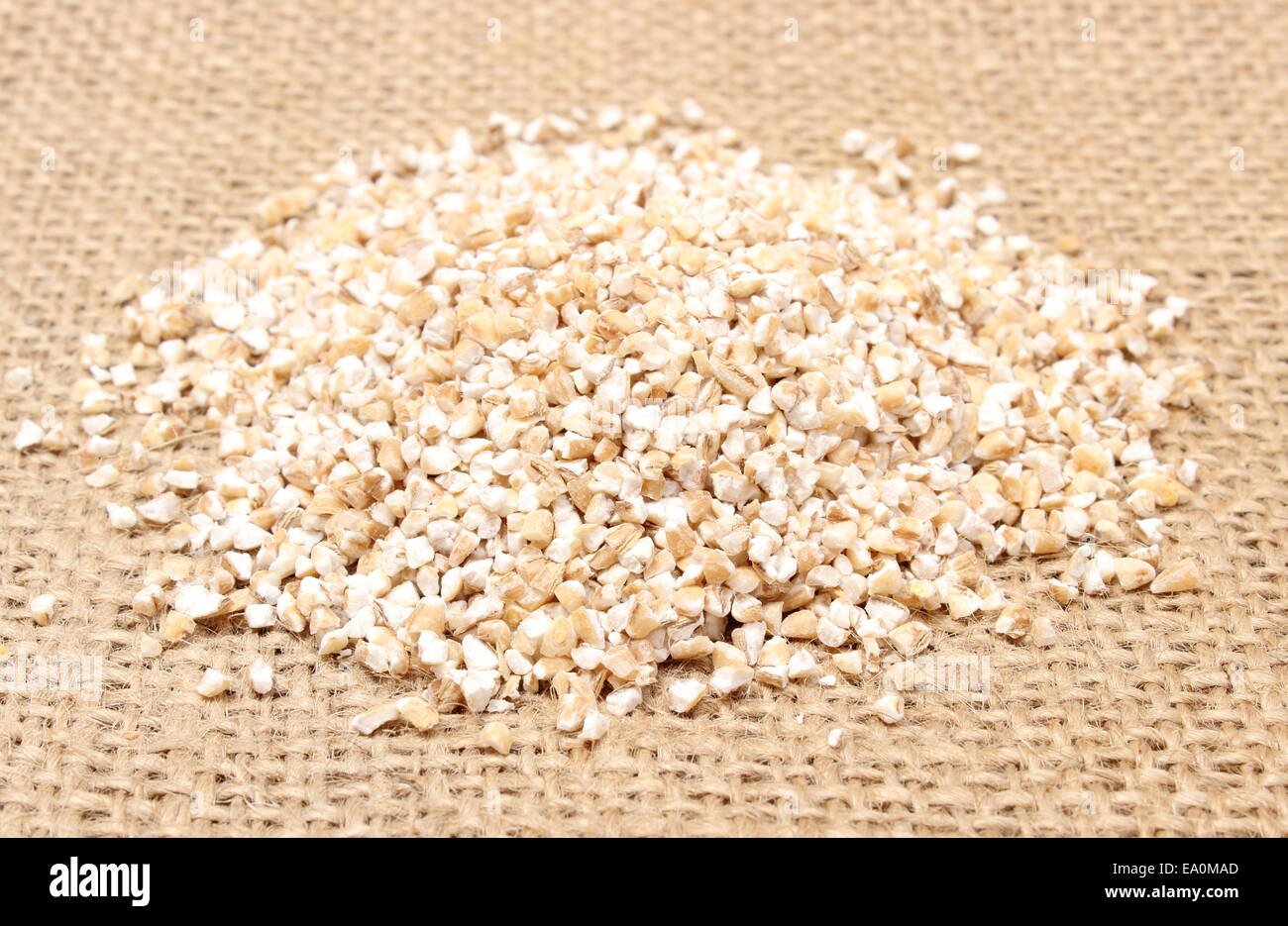 Heap of barley groats lying on jute canvas, healthy food and healthy ...